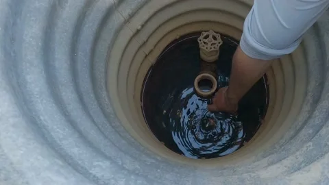 Dipping A Plastic Bottle Into A Well To ... | Stock Video | Pond5