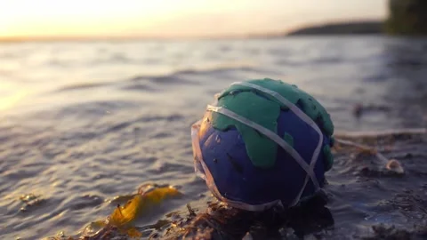 dirty earth model in water, earth pollut... | Stock Video | Pond5