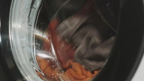 Dirty laundry spinning inside washing ma... | Stock Video | Pond5