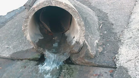 Dirty water flows from the pipe. Environ... | Stock Video | Pond5