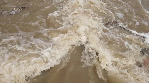 Dirty water stream flows into the river.... | Stock Video | Pond5