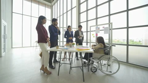 Disabled people with a group of Asian bu... | Stock Video | Pond5