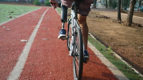 Disabled person riding bicycle with pros... | Stock Video | Pond5