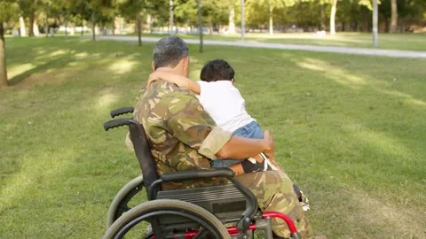 Disabled soldier dad playing with kids i... | Stock Video | Pond5