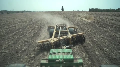 Disc harrow working in dusty field, view... | Stock Video | Pond5