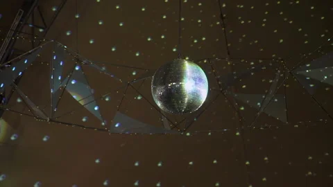 A disco ball suspended from the ceiling ... | Stock Video | Pond5