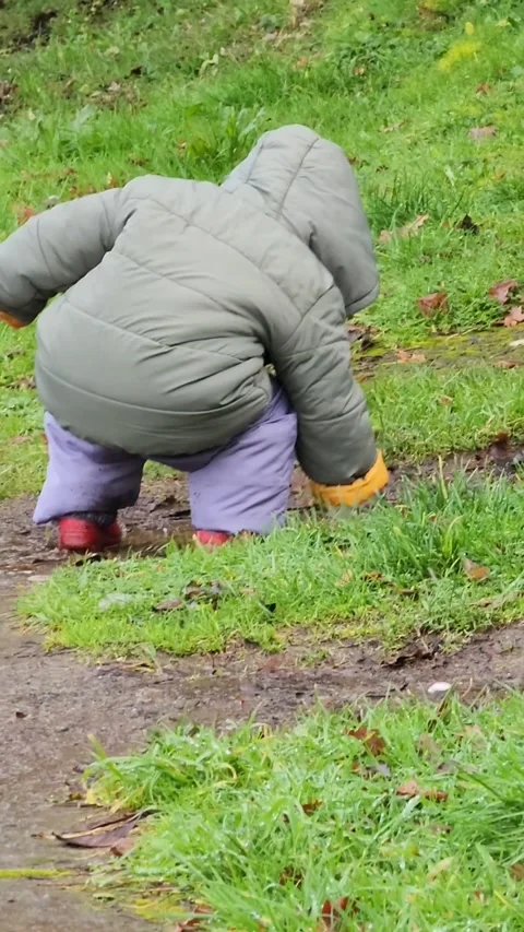 Discovering The Joy Of Muddy Puddles, Ch... | Stock Video | Pond5