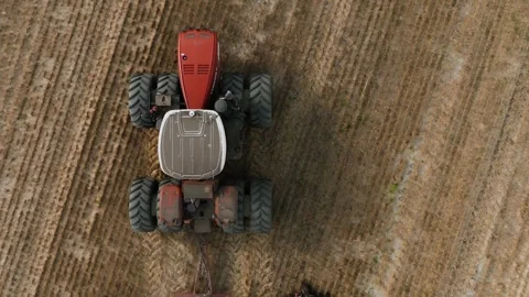 Disking the field. Big red Tractor culti... | Stock Video | Pond5