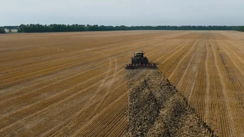 Disking the field. Big red Tractor culti... | Stock Video | Pond5