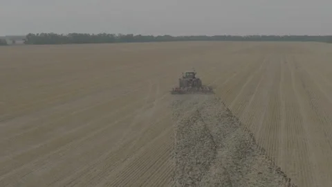 Disking the field. Big red Tractor culti... | Stock Video | Pond5
