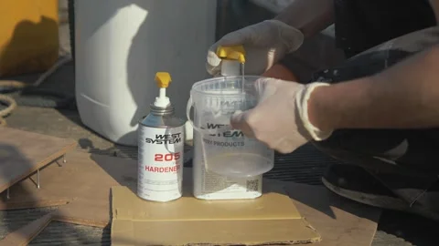 Dispensing and mixing West System Epoxy | Stock Video | Pond5