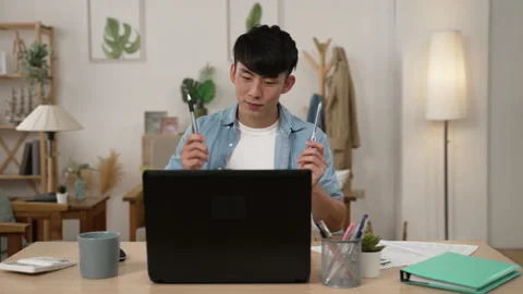 distracted asian young man working from ... | Stock Video | Pond5