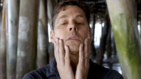 Distraught man looks into camera and gra... | Stock Video | Pond5