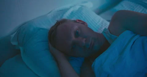 Disturbed thoughtful guy awake late lyin... | Stock Video | Pond5