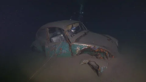 Diver near a Volkswagen Beetle wreck und... | Stock Video | Pond5