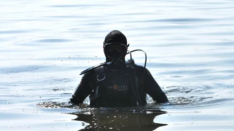 Diver rescuer in black diving equipment ... | Stock Video | Pond5
