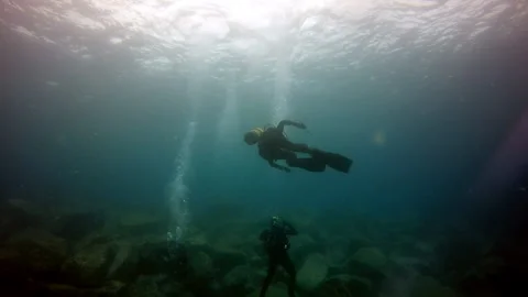 Divers dive to bottom of Atlantic ocean. | Stock Video | Pond5