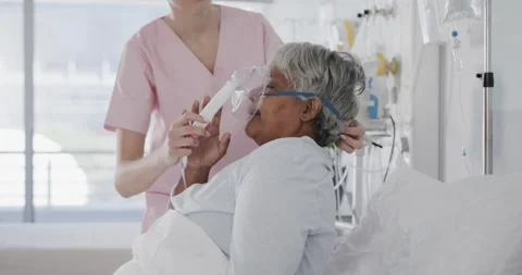 Diverse female doctor giving oxygen mask... | Stock Video | Pond5