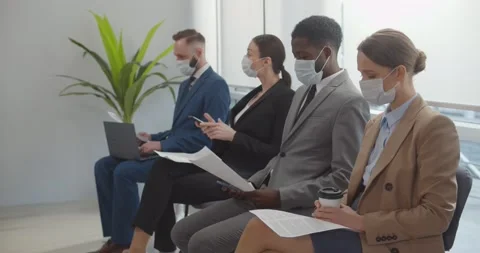 Diverse job candidates in safety mask si... | Stock Video | Pond5