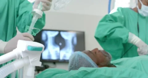 Diverse surgeons giving anesthesia to pa... | Stock Video | Pond5