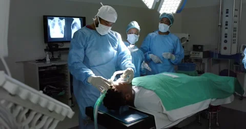 Diverse surgeons giving anesthesia to pa... | Stock Video | Pond5