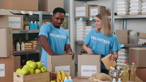 Diverse volunteers sorting food for dona... | Stock Video | Pond5