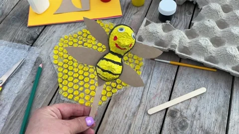 A diy honey bee toy on a stick made from... | Stock Video | Pond5