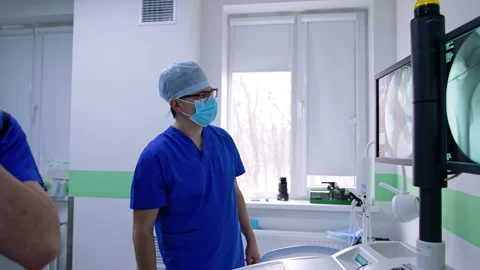 Doctor in blue x-ray protective suit poi... | Stock Video | Pond5
