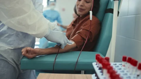 Doctor Checking Blood Drawing Process | Stock Video | Pond5