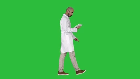 Doctor checking his tablet walking on a ... | Stock Video | Pond5