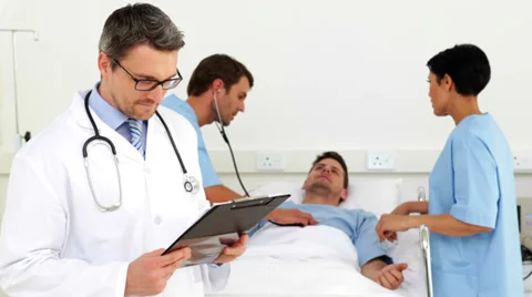 Doctor checking sick patients chart | Stock Video | Pond5