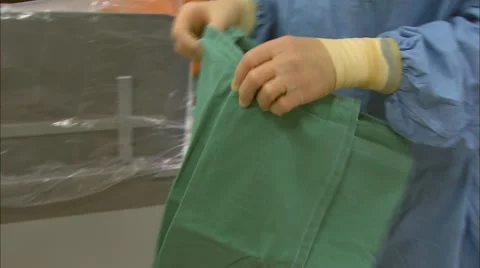 Doctor draping patient with sheet | Stock Video | Pond5