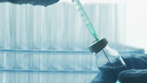 A doctor is drawing up vaccine from phia... | Stock Video | Pond5