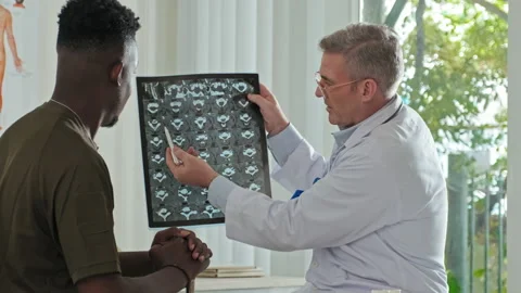 Doctor Explaining CT Scan Image to Black... | Stock Video | Pond5
