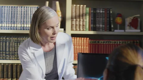A doctor explains an x-ray scan to a pat... | Stock Video | Pond5