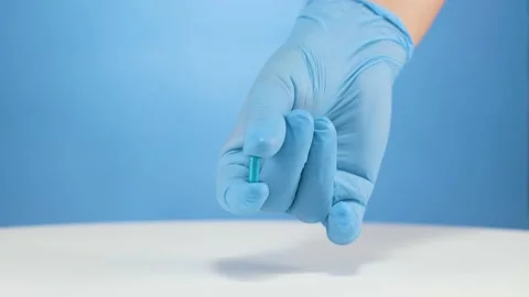 Doctor with gloves shows a blue painkill... | Stock Video | Pond5