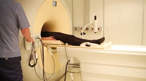 The doctor moves the MRI scanner bed wit... | Stock Video | Pond5