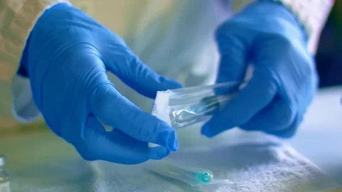 Doctor opens sterile syringe packaging f... | Stock Video | Pond5