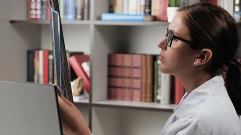 Doctor reads x-ray or MRI scan. Woman do... | Stock Video | Pond5