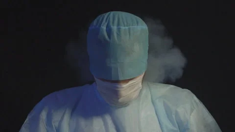 Doctor surgeon stands in smoke on black ... | Stock Video | Pond5