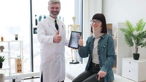 Doctor with tablet and lady in neck brac... | Stock Video | Pond5