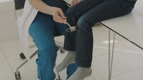 Doctor Testing Boy'S Reflexes With Refle... | Stock Video | Pond5