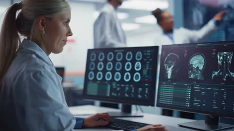 Doctor Uses Computer with MRI Scan | Stock Video | Pond5