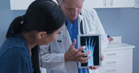 Doctor using tablet computer with x-ray ... | Stock Video | Pond5