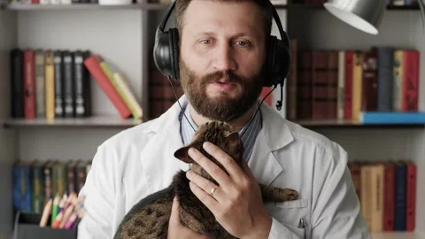 Doctor vet talking to camera. Attractive... | Stock Video | Pond5