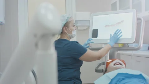 Doctor woman makes a 3d scan of the teet... | Stock Video | Pond5