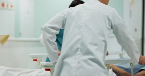 Doctors, people talking and push patient... | Stock Video | Pond5