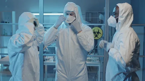 Doctors Putting on Hazmat Suits | Stock Video | Pond5
