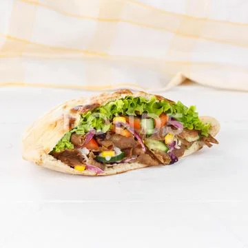 Doener Kebab Doner Kebap half fast food meal in pita bread on wooden ...