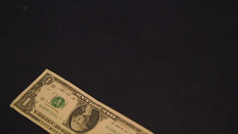 Dollar Bill Sliding on a Table | Stock Video | Pond5